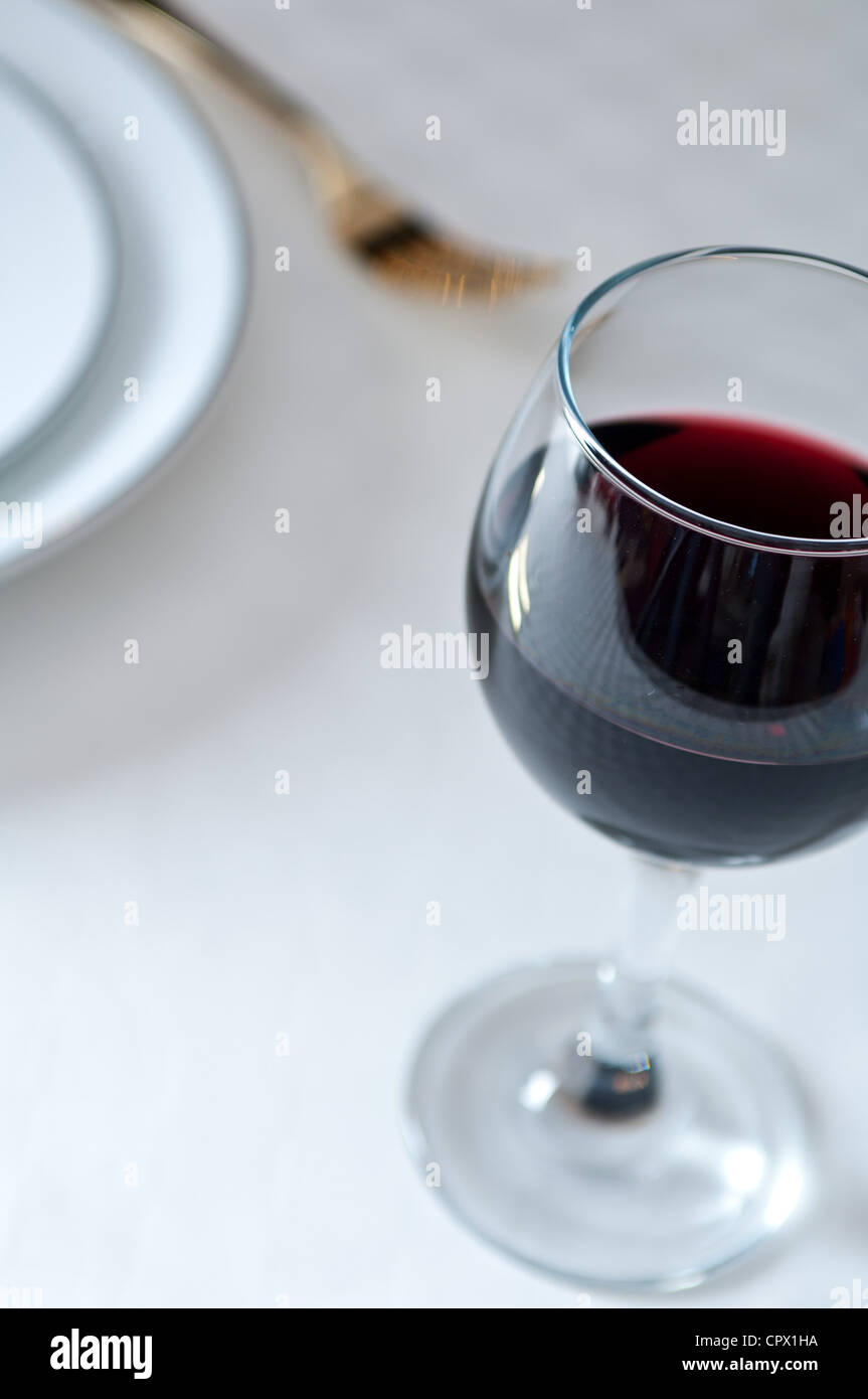Glass of red wine on table Stock Photo - Alamy