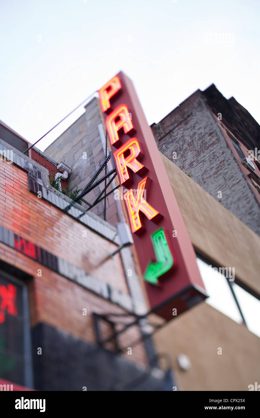 Neon parking sign on building Stock Photo - Alamy