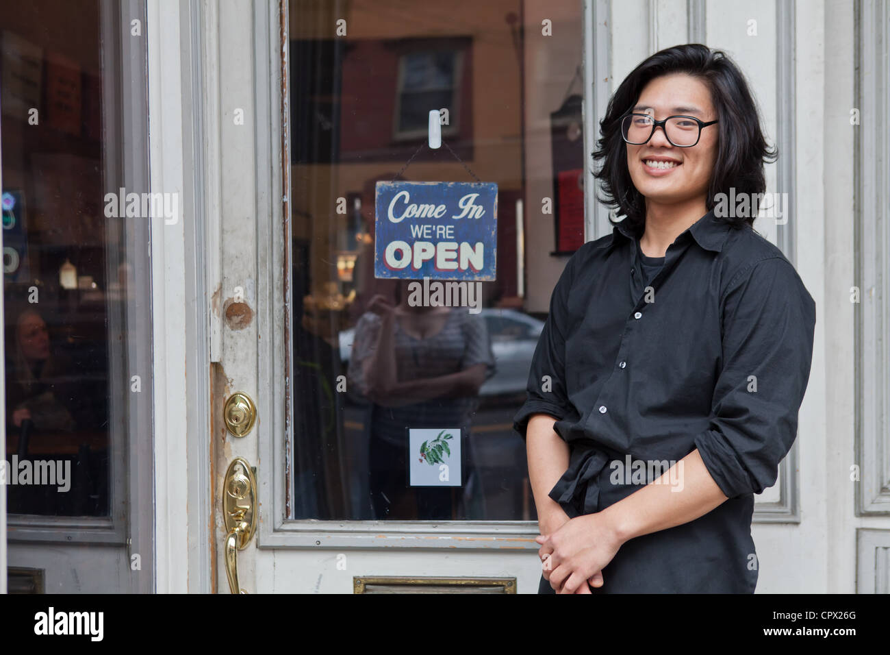 Young male worker outside cafe Stock Photo - Alamy