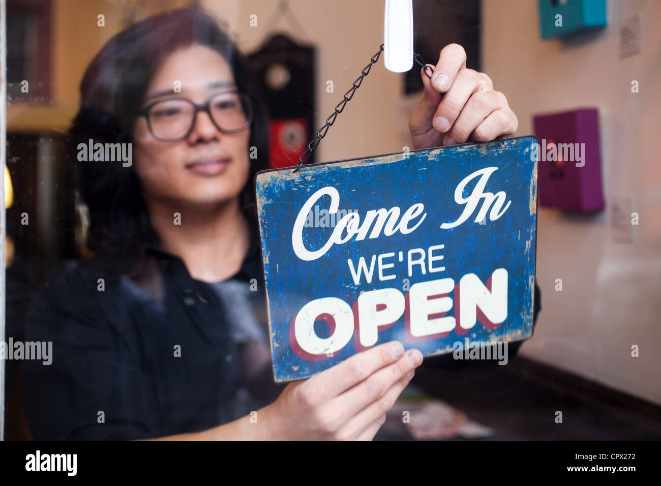 Young man opening shop Stock Photo - Alamy