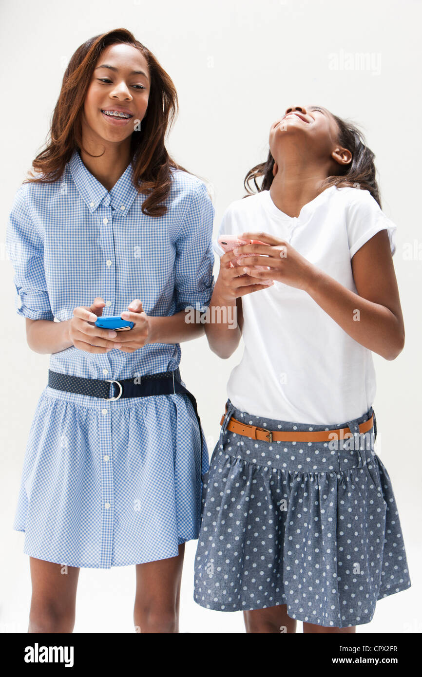 African American sisters laughing together, studio shot Stock Photo - Alamy