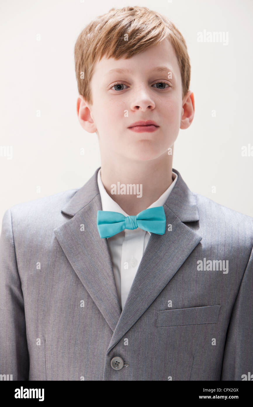 Boy wearing grey suit and bow tie, studio shot Stock Photo - Alamy