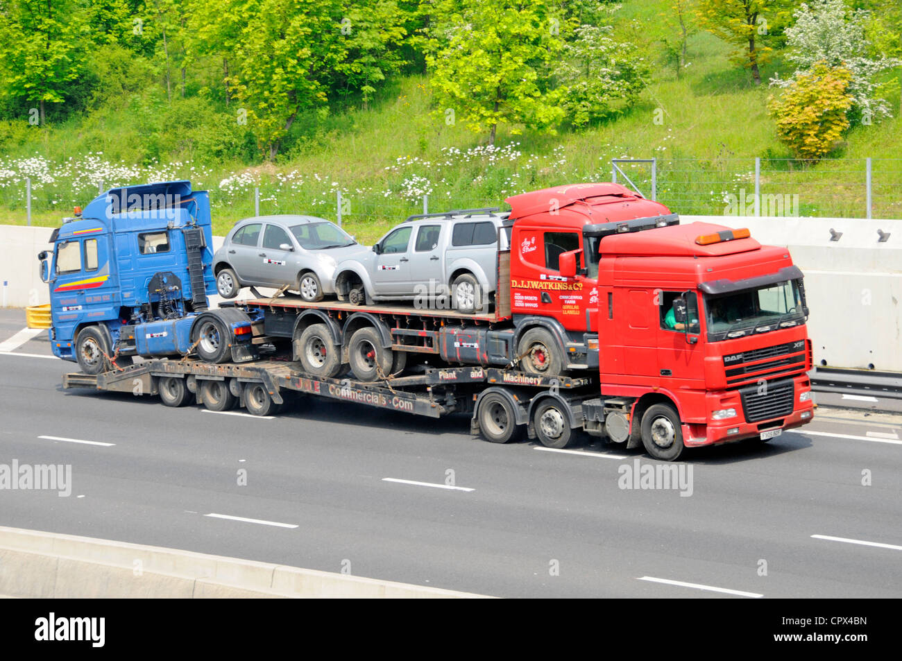 Lorry and low loader trailer carrying an unusual load of 4 assorted ...