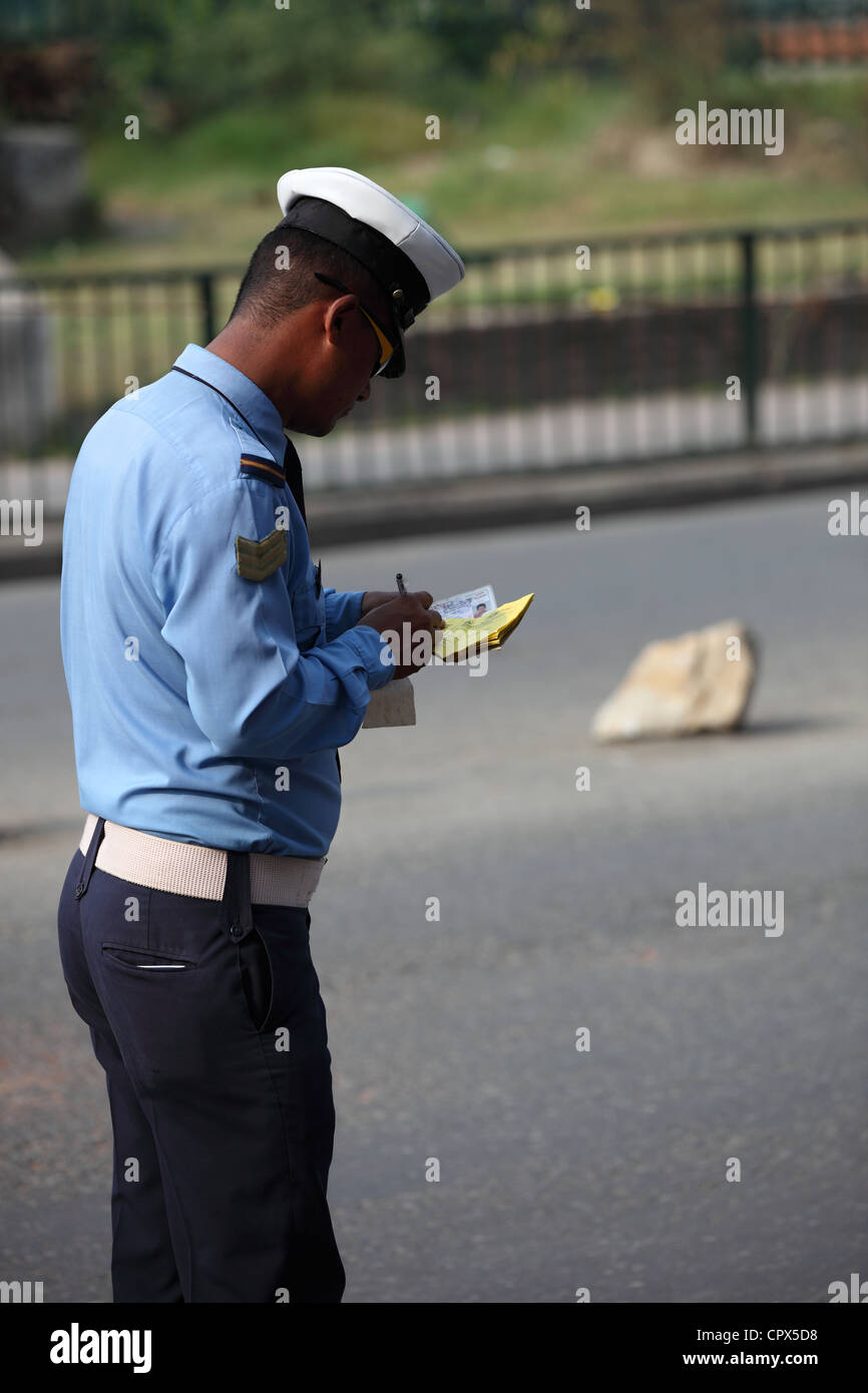 Police officer writing a fine Nepal Stock Photo - Alamy