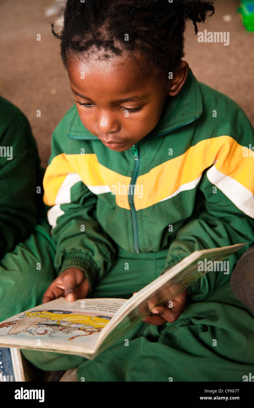 A young girl reading a book at school, Meyerton Primary School ...