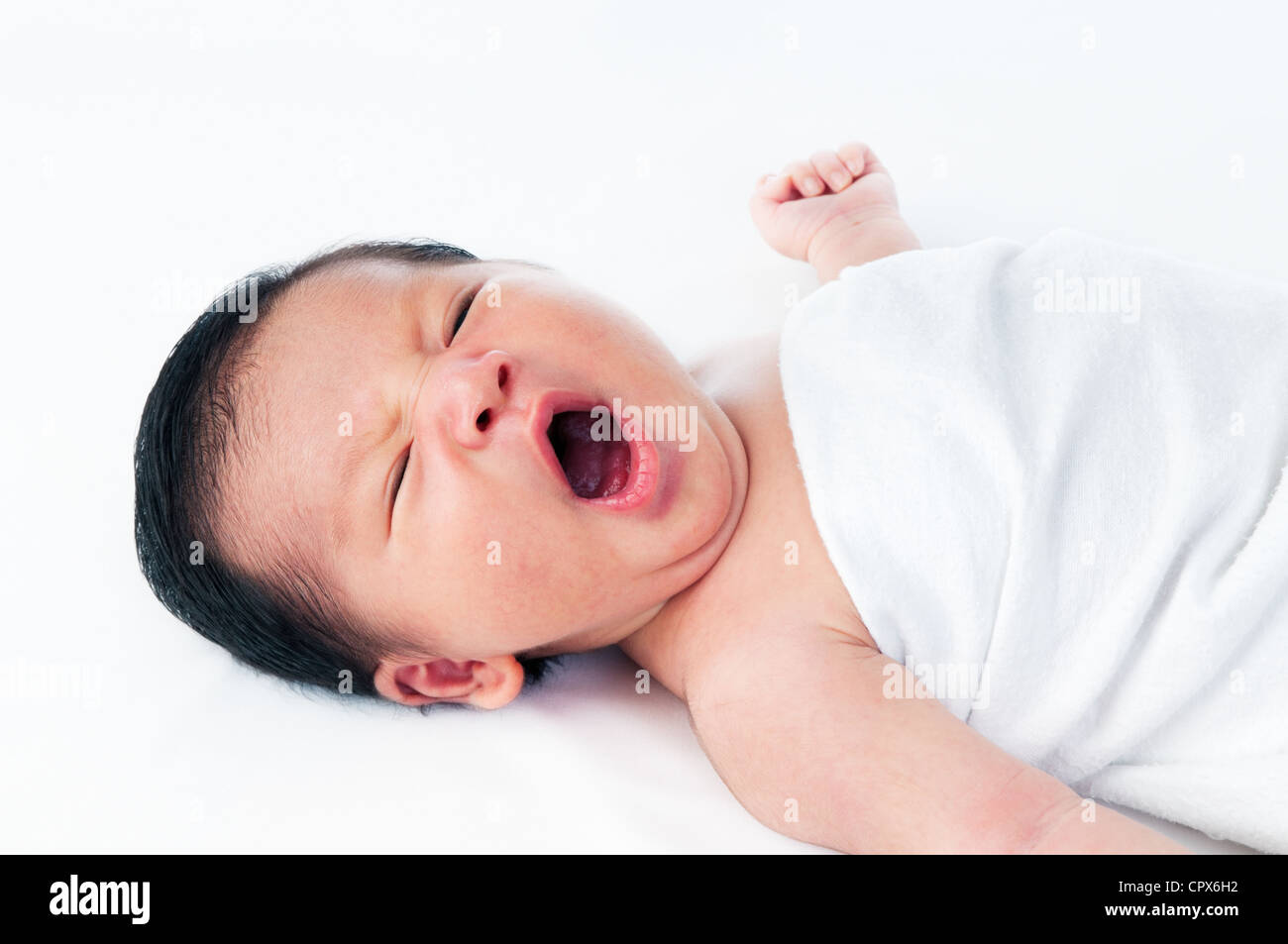 Newborn infant baby yawning, portrait Stock Photo - Alamy