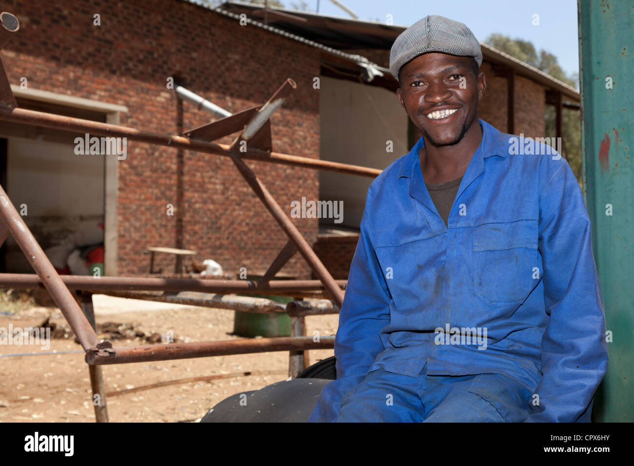 African farmworker sitting outdoors, smiling at camera Stock Photo - Alamy
