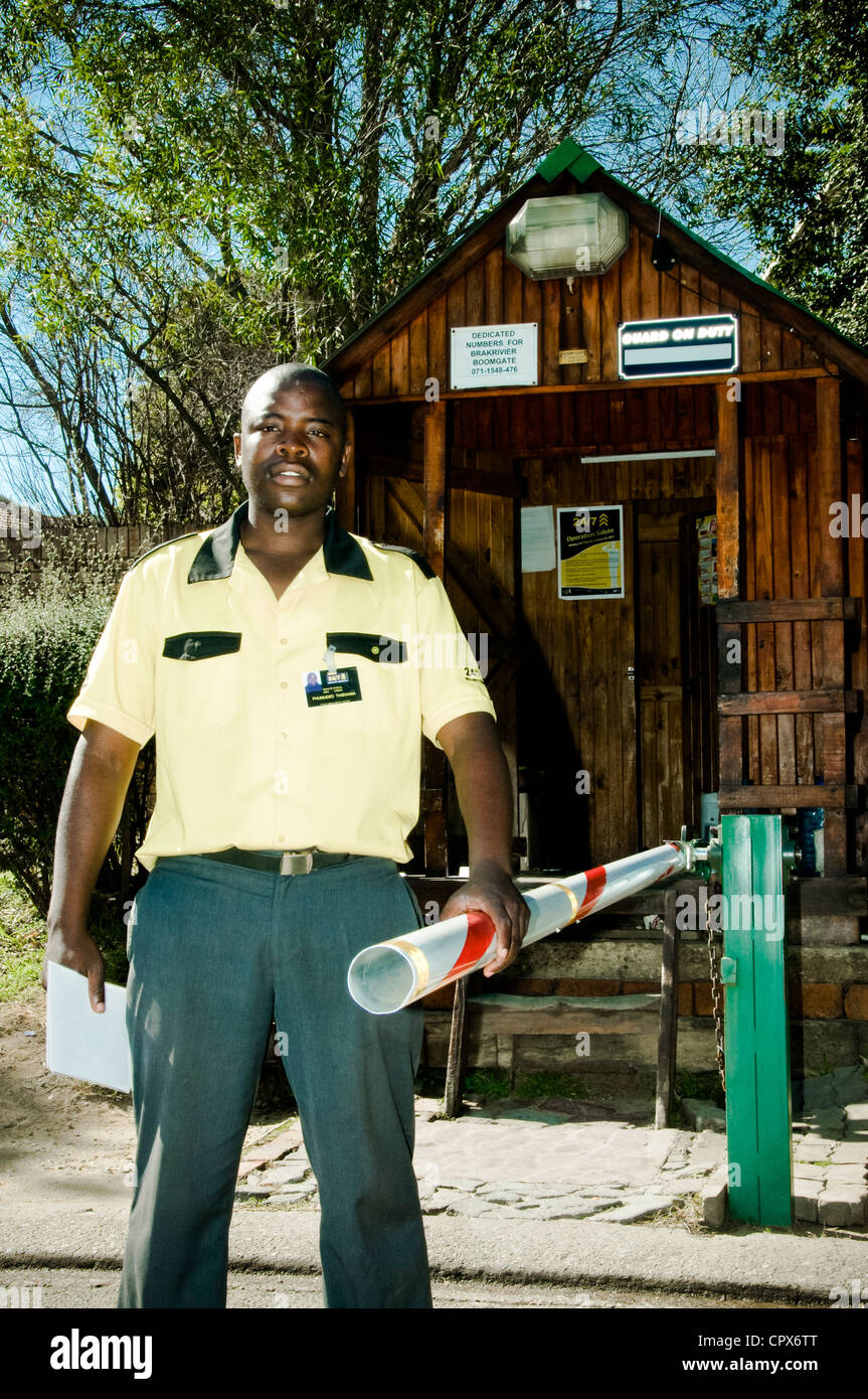 A security guard guarding a boom gate Stock Photo - Alamy