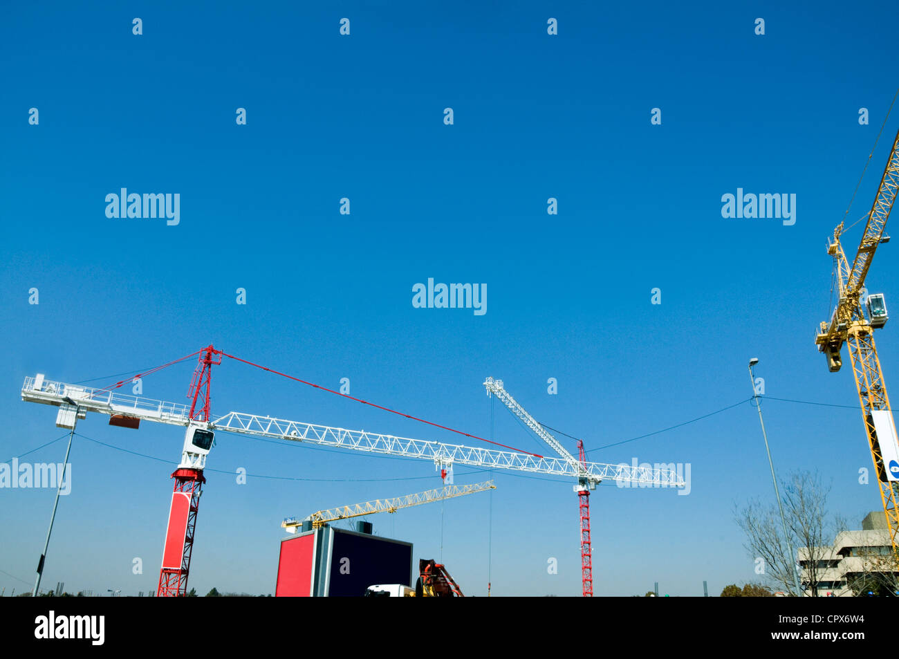 Closeup of cranes carrying out construction work Stock Photo - Alamy