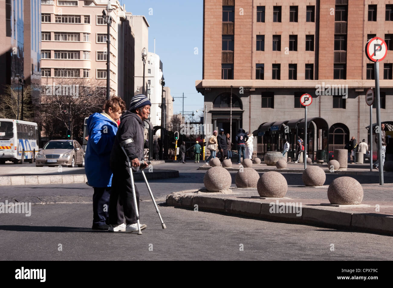 Landscape shot of two homeless people walking together through the city ...