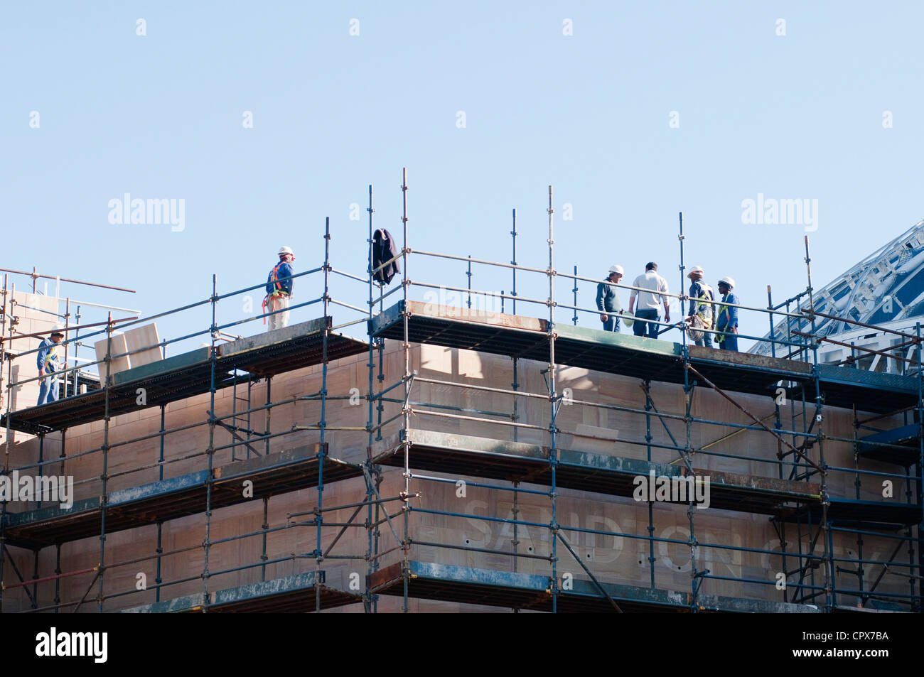 Construction workers stand on scaffolding hi-res stock photography and ...