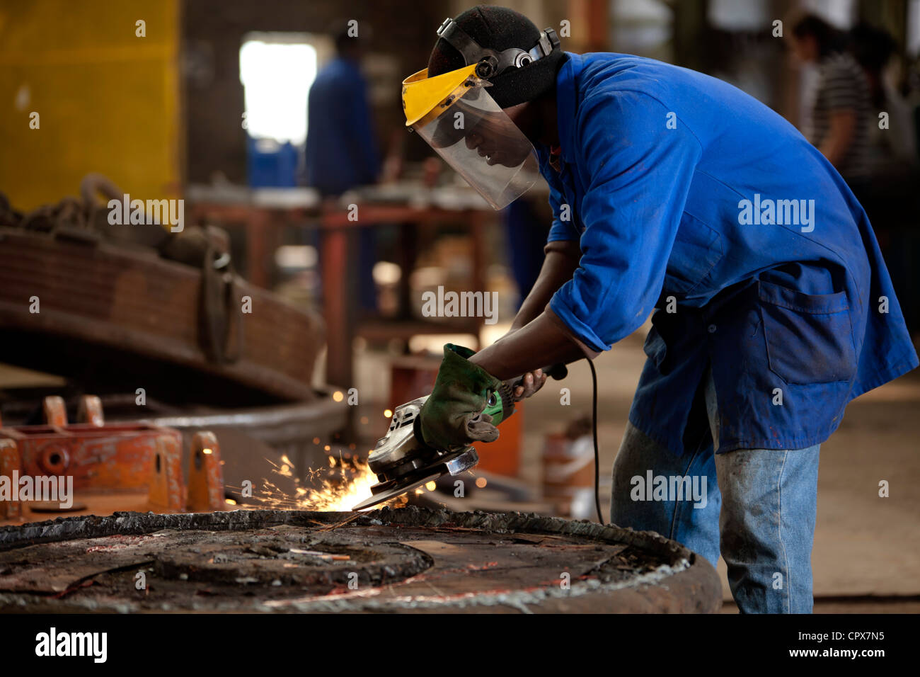Grinding an industrial magnet in a magnet factory, Gauteng, South ...