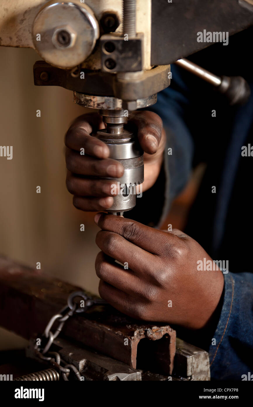 Factory worker operating drill press in magnet factory, Gauteng, South ...