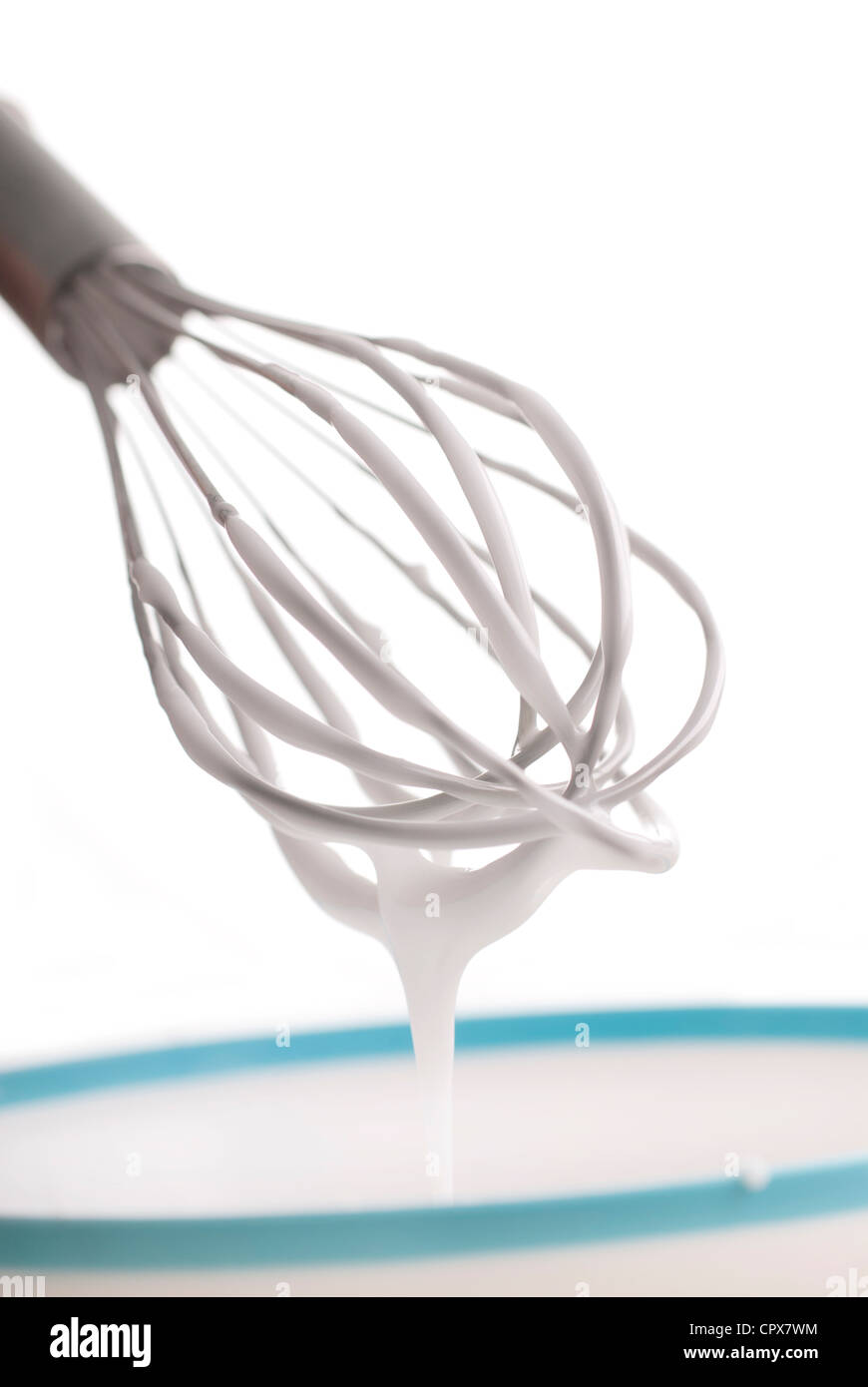 whisk and a white cream Stock Photo - Alamy