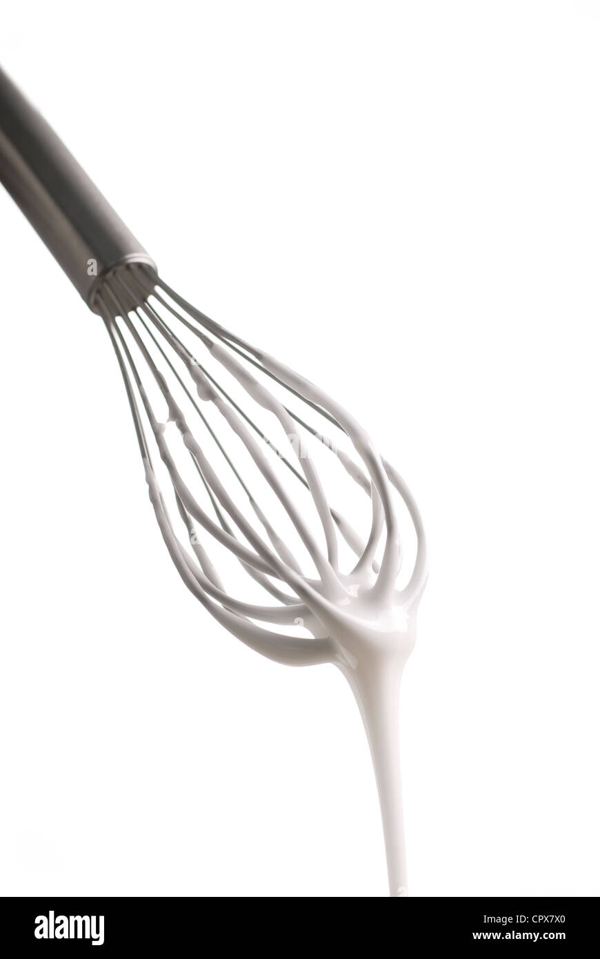 whisk and a white cream Stock Photo - Alamy