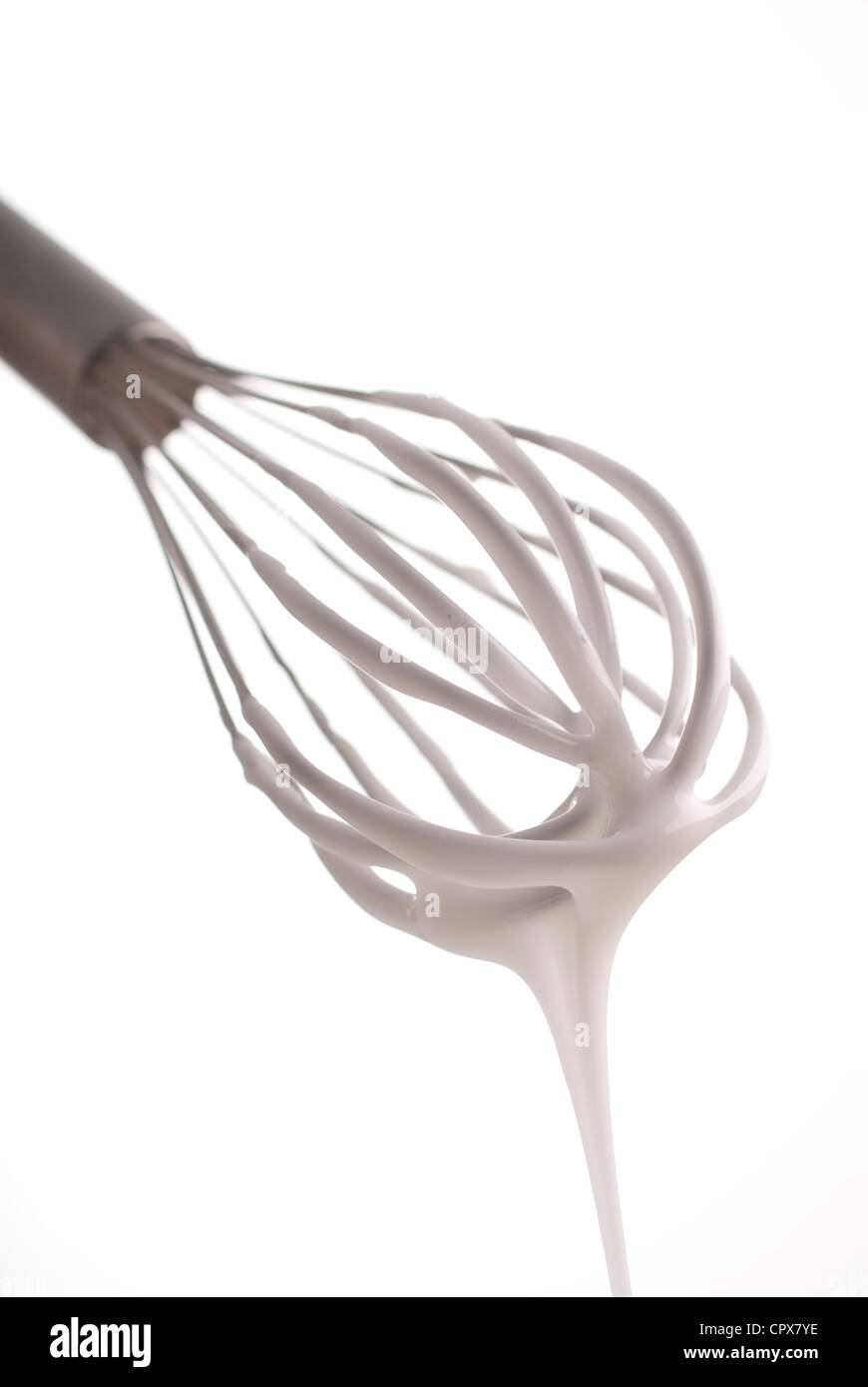 whisk and a white cream Stock Photo - Alamy
