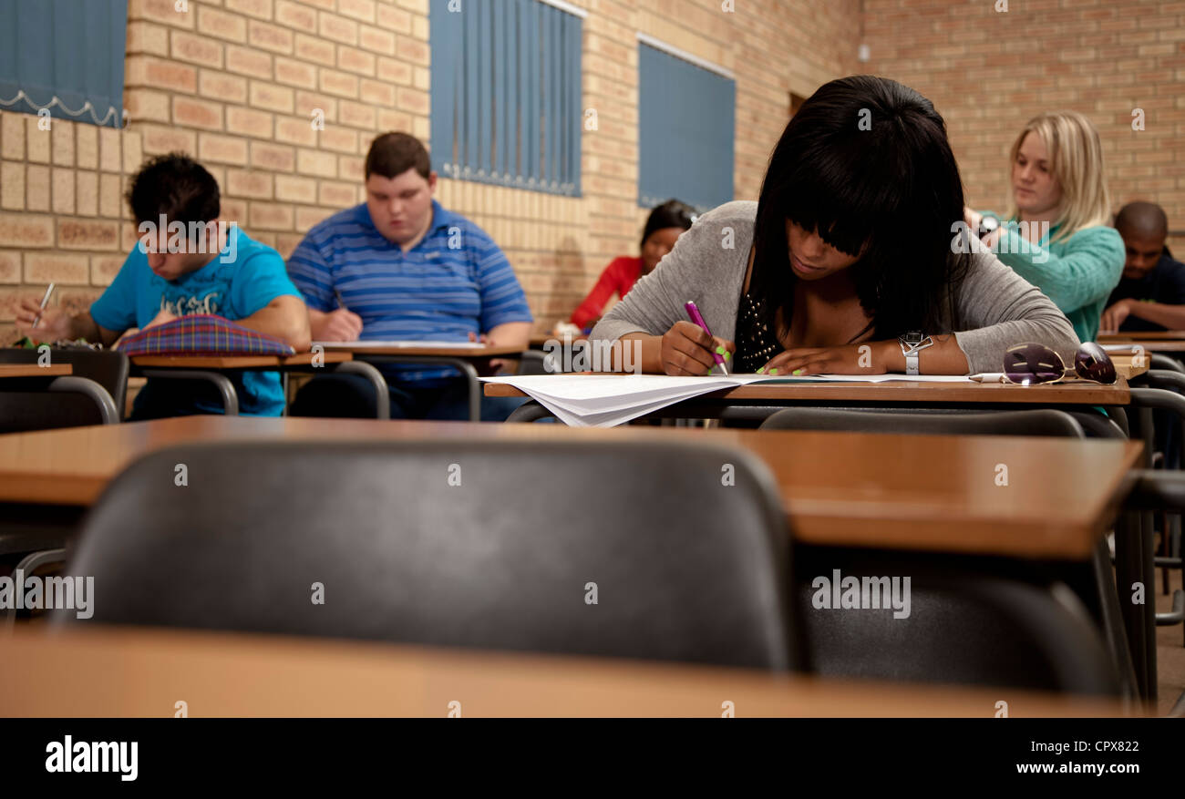 Low angle perspective shot of students working at desks Stock Photo - Alamy