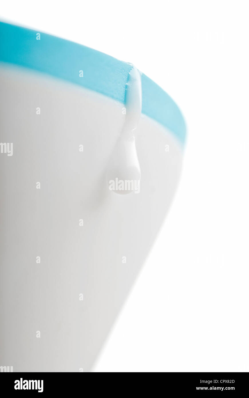 milk dripping from a cup Stock Photo - Alamy