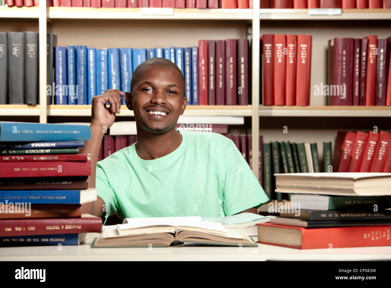 Male student studying and smiling at camera Stock Photo - Alamy