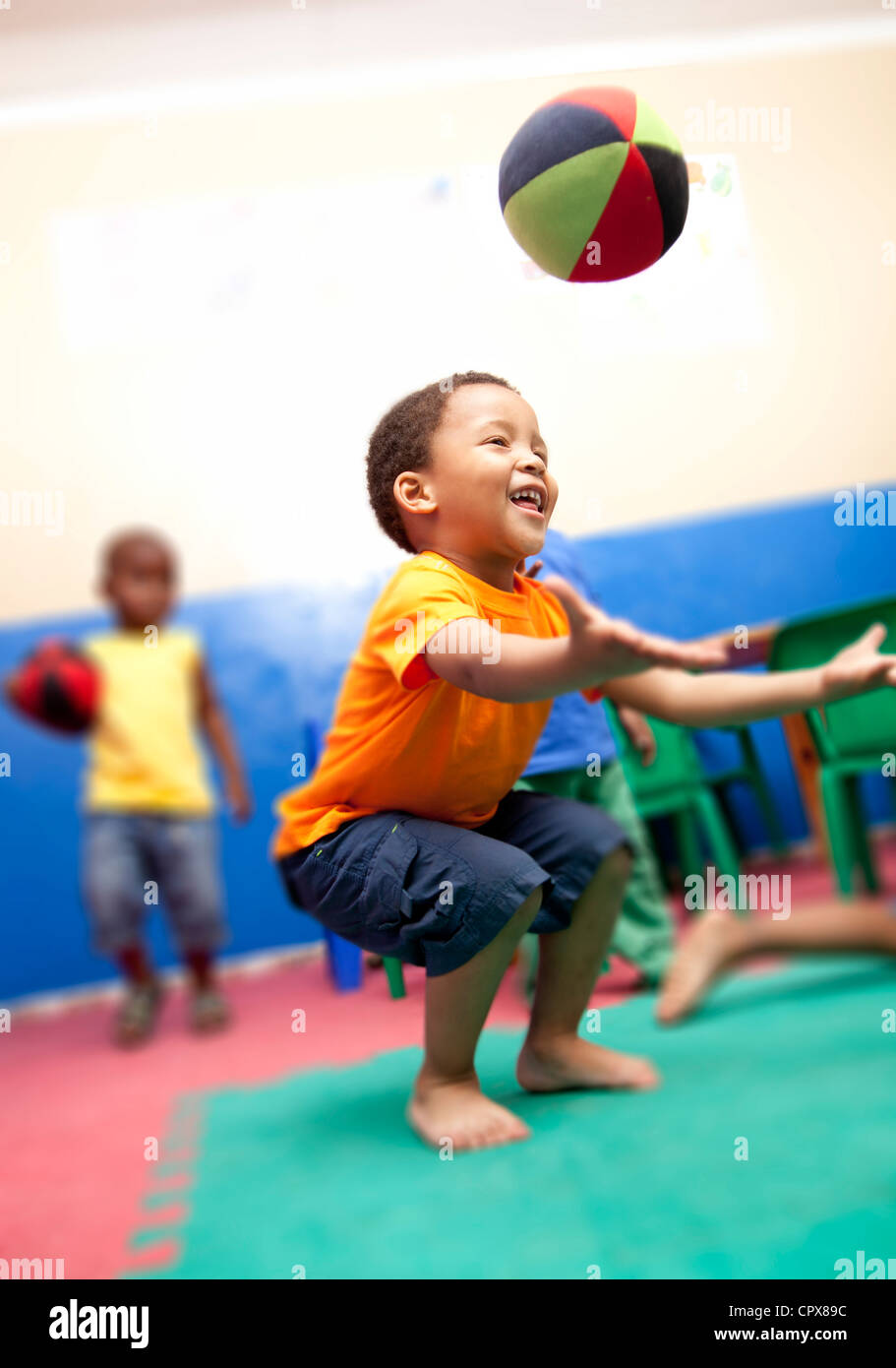 Child playing with a ball indoors Stock Photo - Alamy
