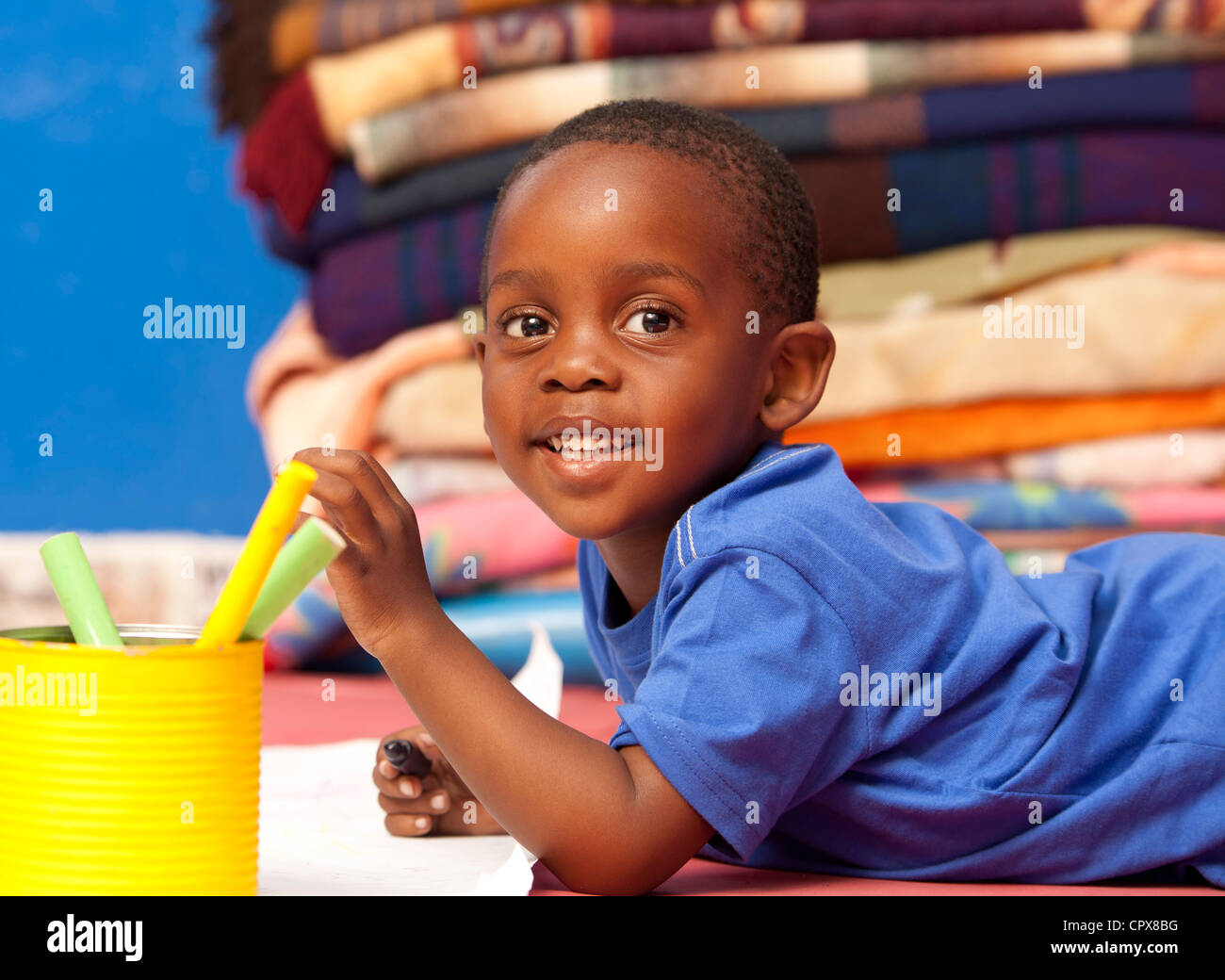 Child lying on the floor drawing Stock Photo - Alamy