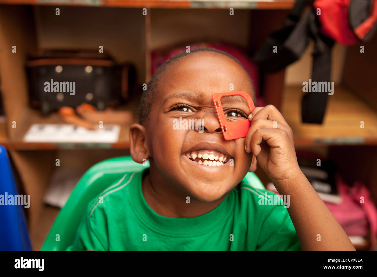 Child looking through toy frame, smiling Stock Photo - Alamy