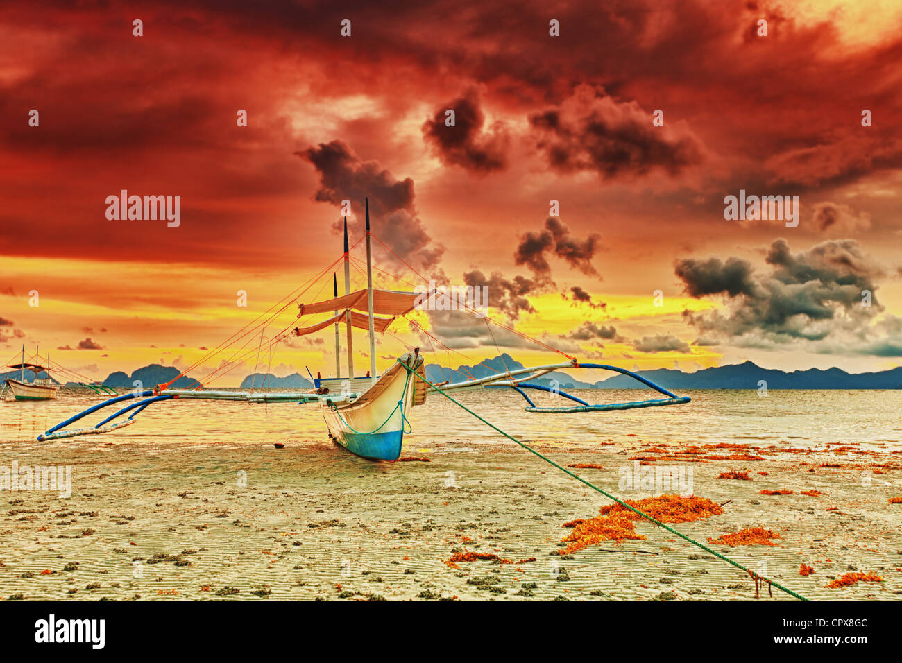 Traditional philippine boat bangka at sunset time Stock Photo - Alamy