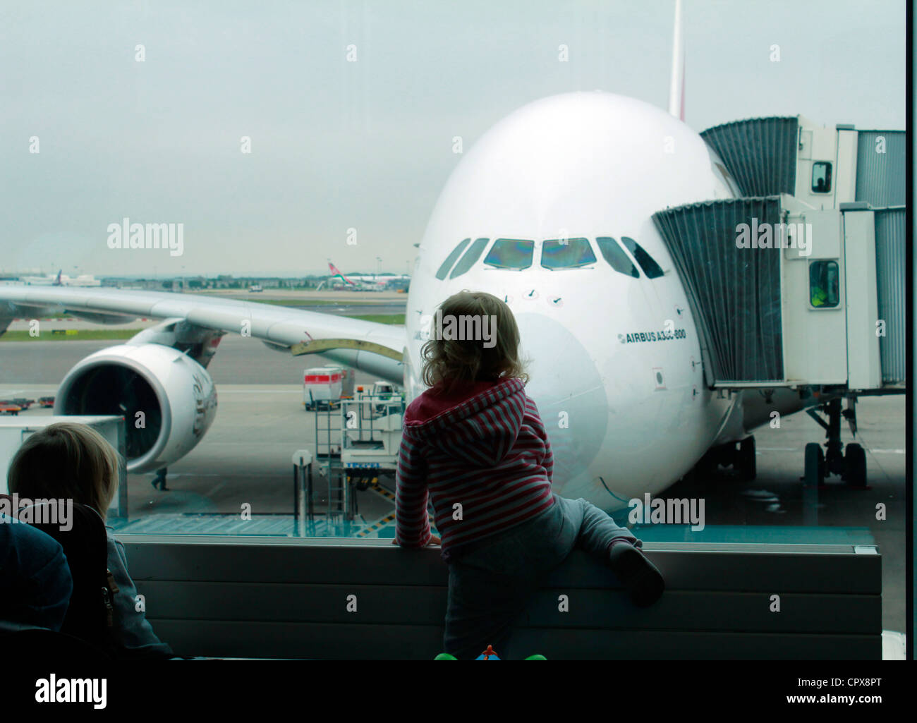 Two kids watching an Airbus A380 as they wait to board the flight Stock ...