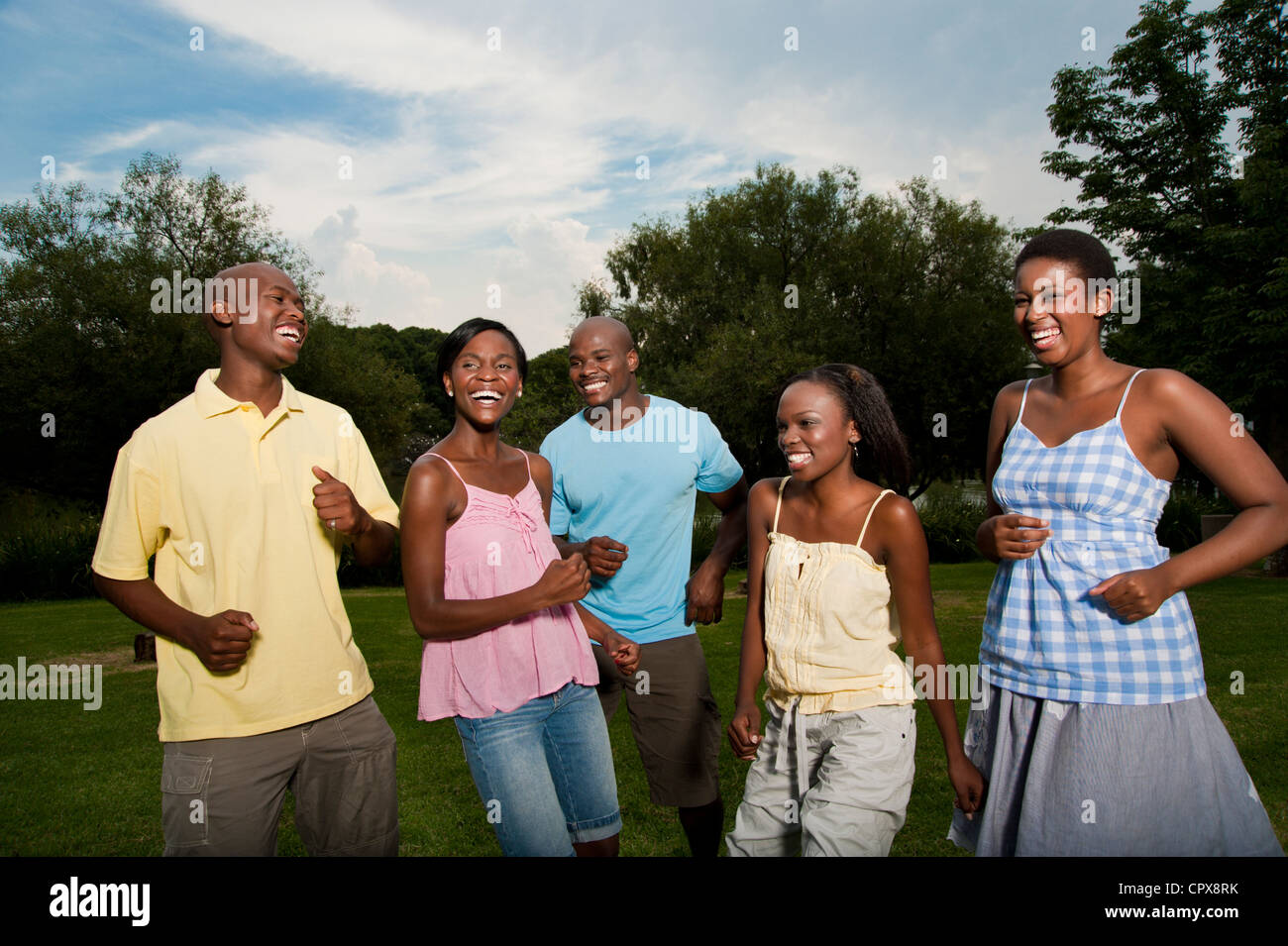 A group of young African friends dance together in a park Stock Photo ...