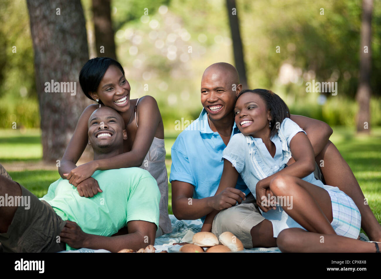 A group of young African friends picnic together in a park Stock Photo ...