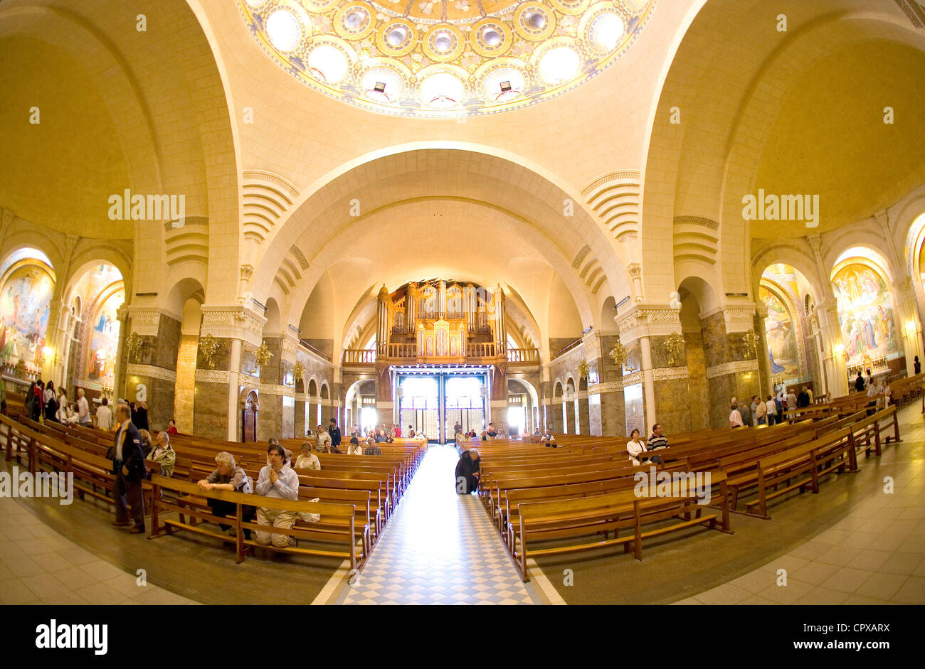 Christian pilgrims inside the Rosary Basilica, Lourdes, Midi-Pyrenees ...