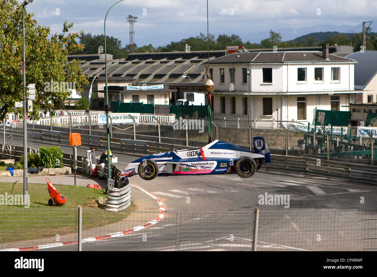 Smashed car gets lifted off the street circuit by a crane during a ...