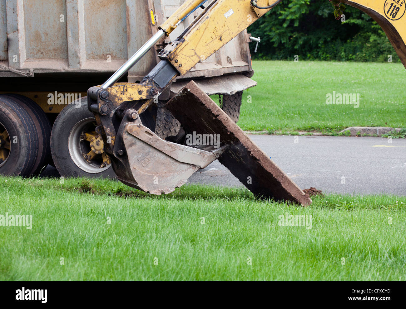Backhoe, truck, lorry sidewalk construction repair work Stock Photo - Alamy