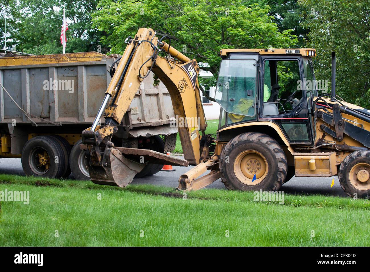 Backhoe, truck, lorry sidewalk construction repair work Stock Photo - Alamy