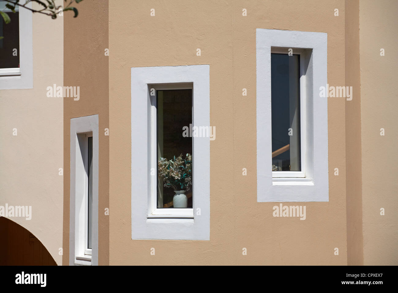 long tall windows in housing complex one with vase of flowers in at ...