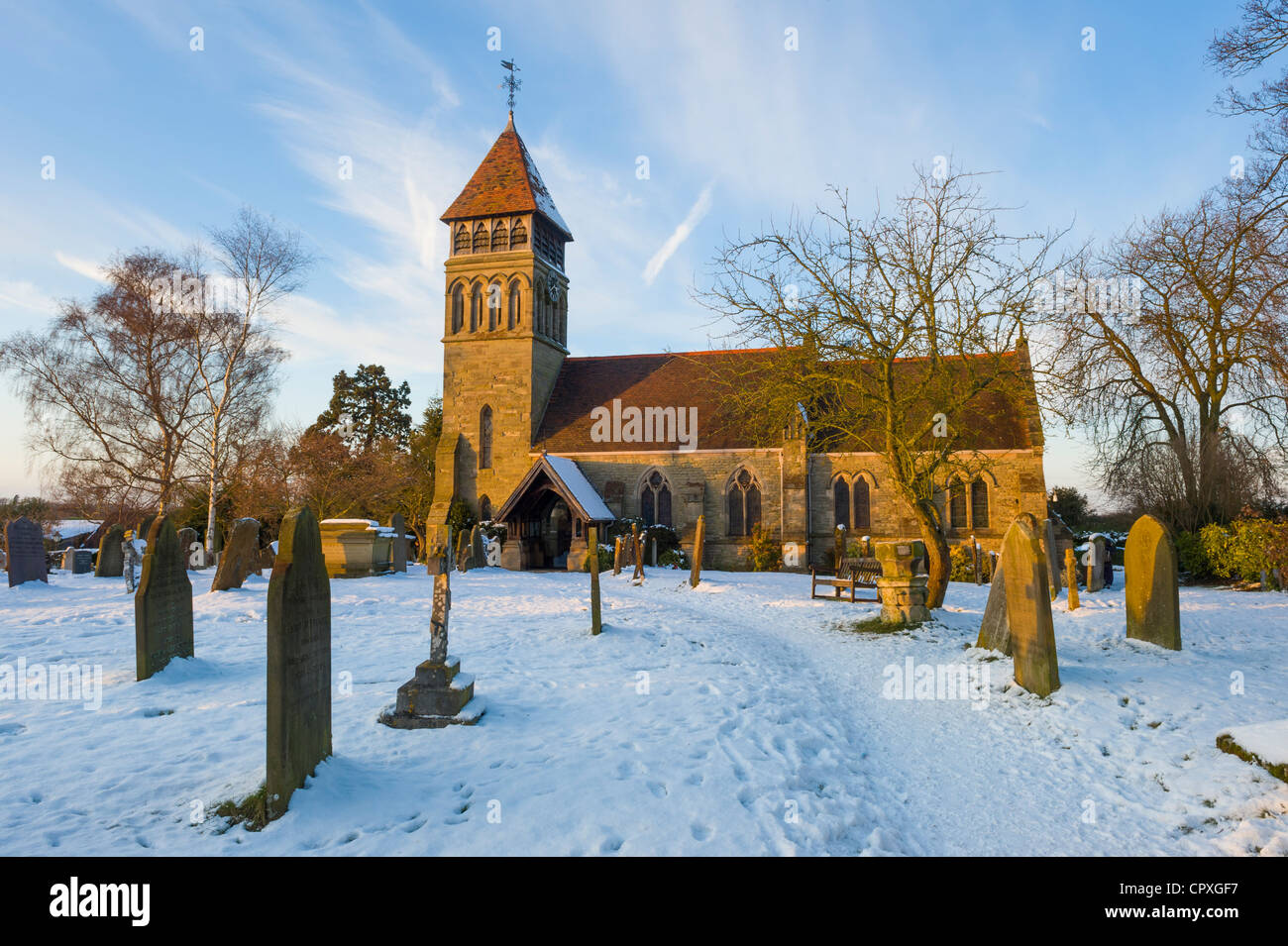 A snow covered winter sunset at the Old Milverton church, Old Milverton ...