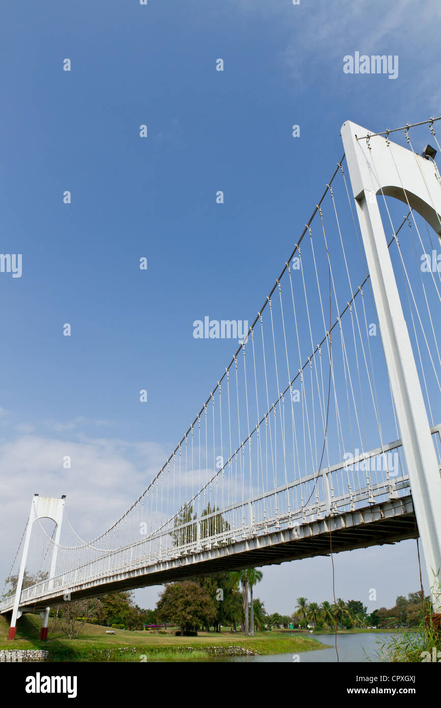 White sling bridge in a park Stock Photo - Alamy