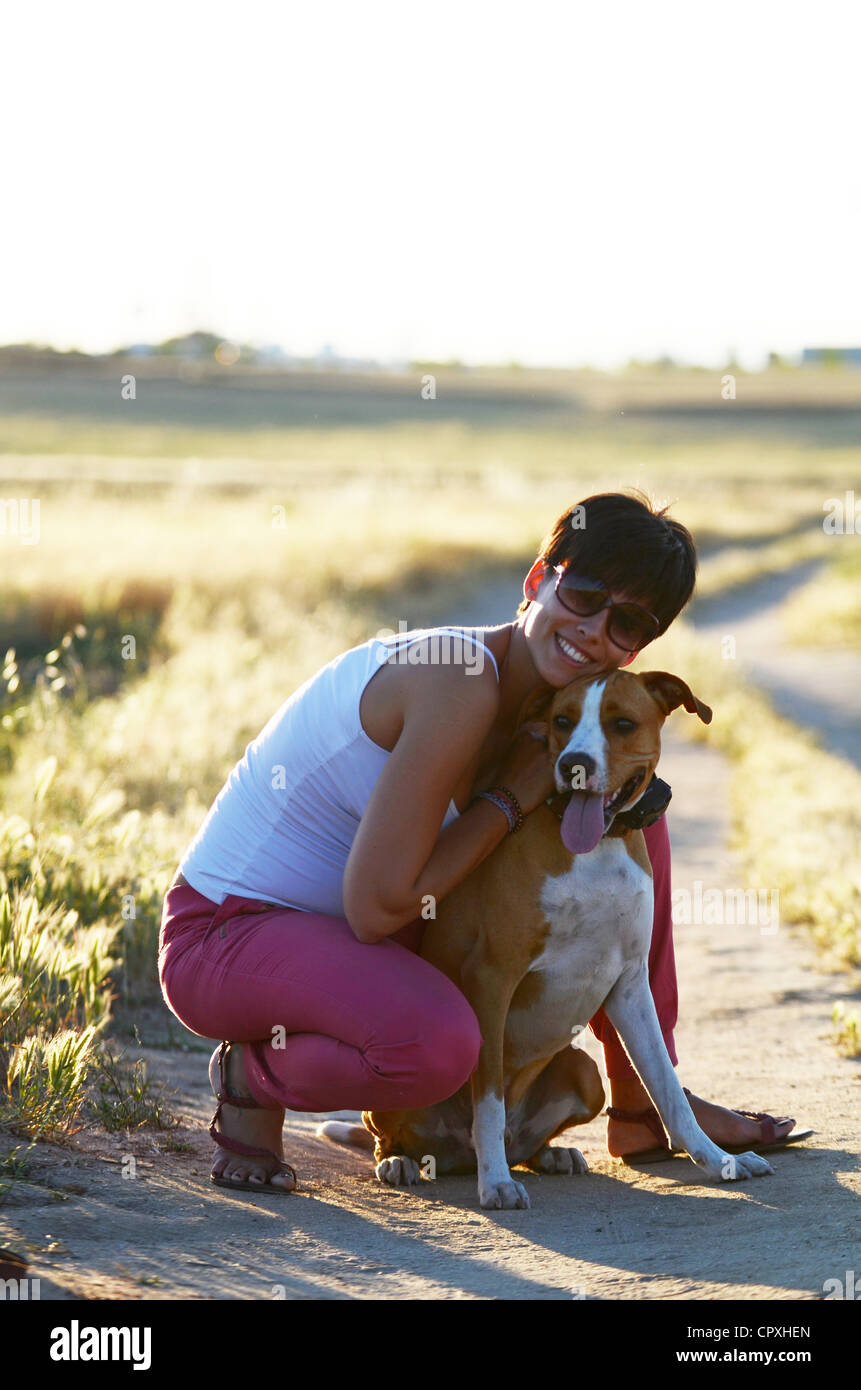 Attractive young woman with her dog in nature Stock Photo - Alamy