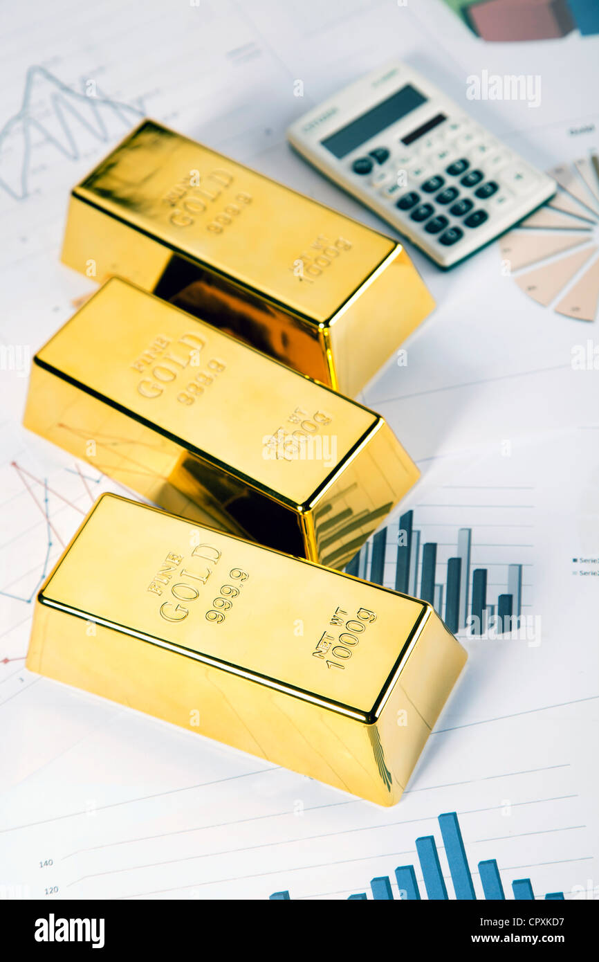 Gold bars on graphs and statistics Stock Photo - Alamy