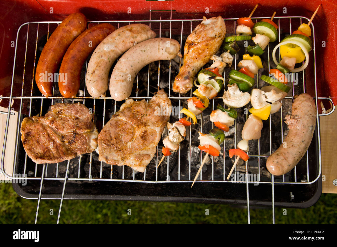 Closeup of fried meat on grill Stock Photo - Alamy
