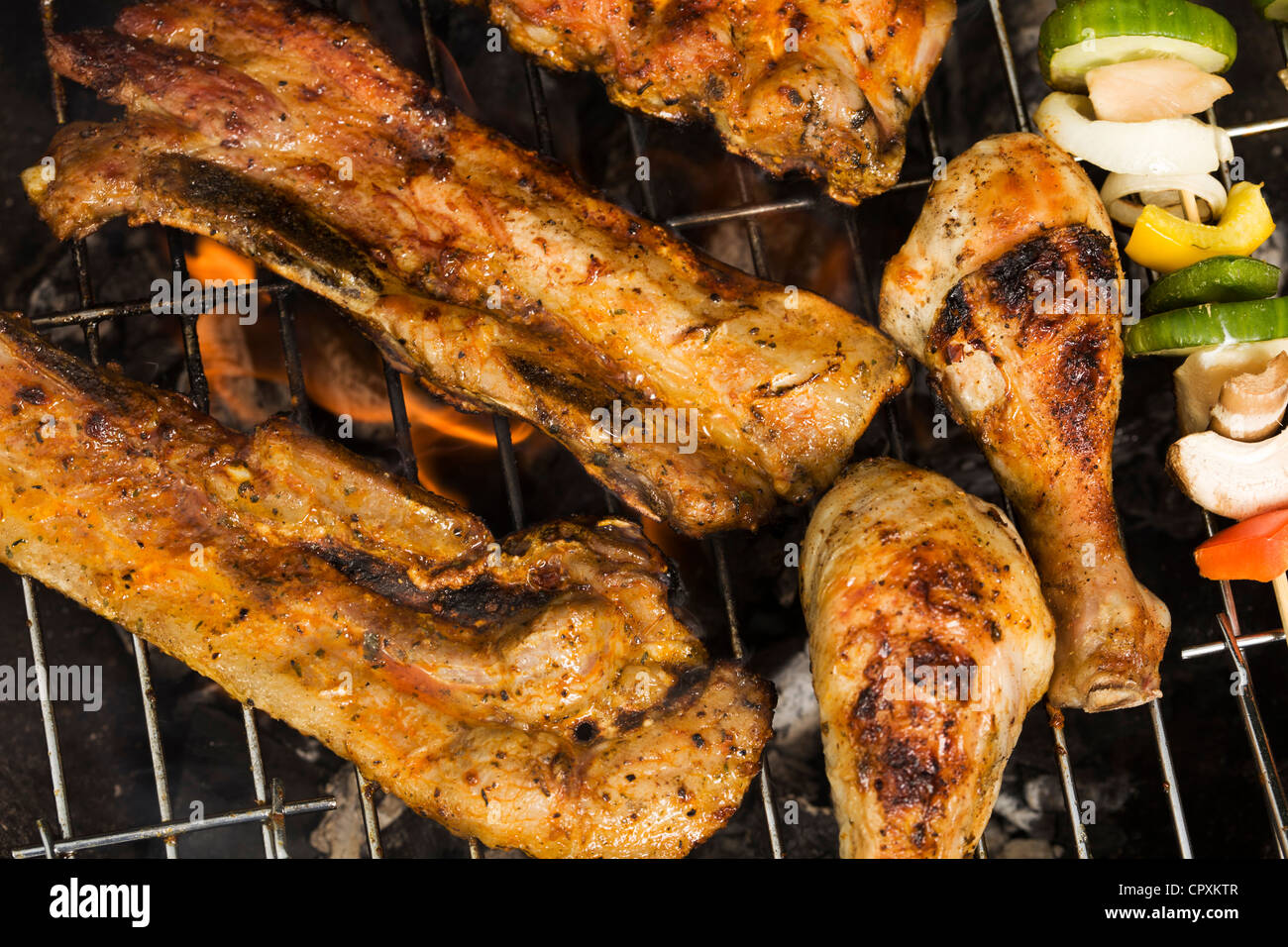 Closeup of fried meat on grill Stock Photo - Alamy
