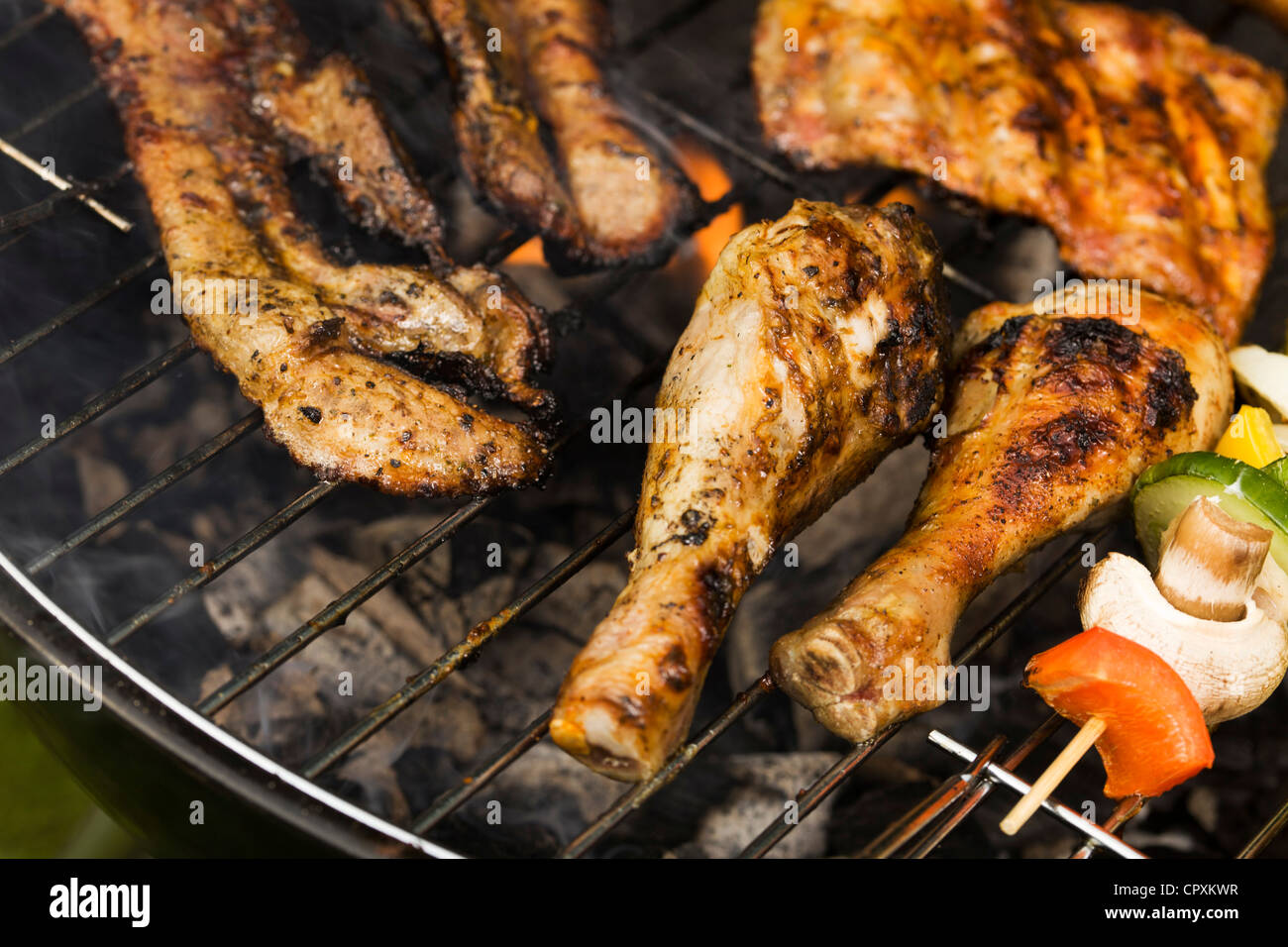 Closeup of fried meat on grill Stock Photo - Alamy