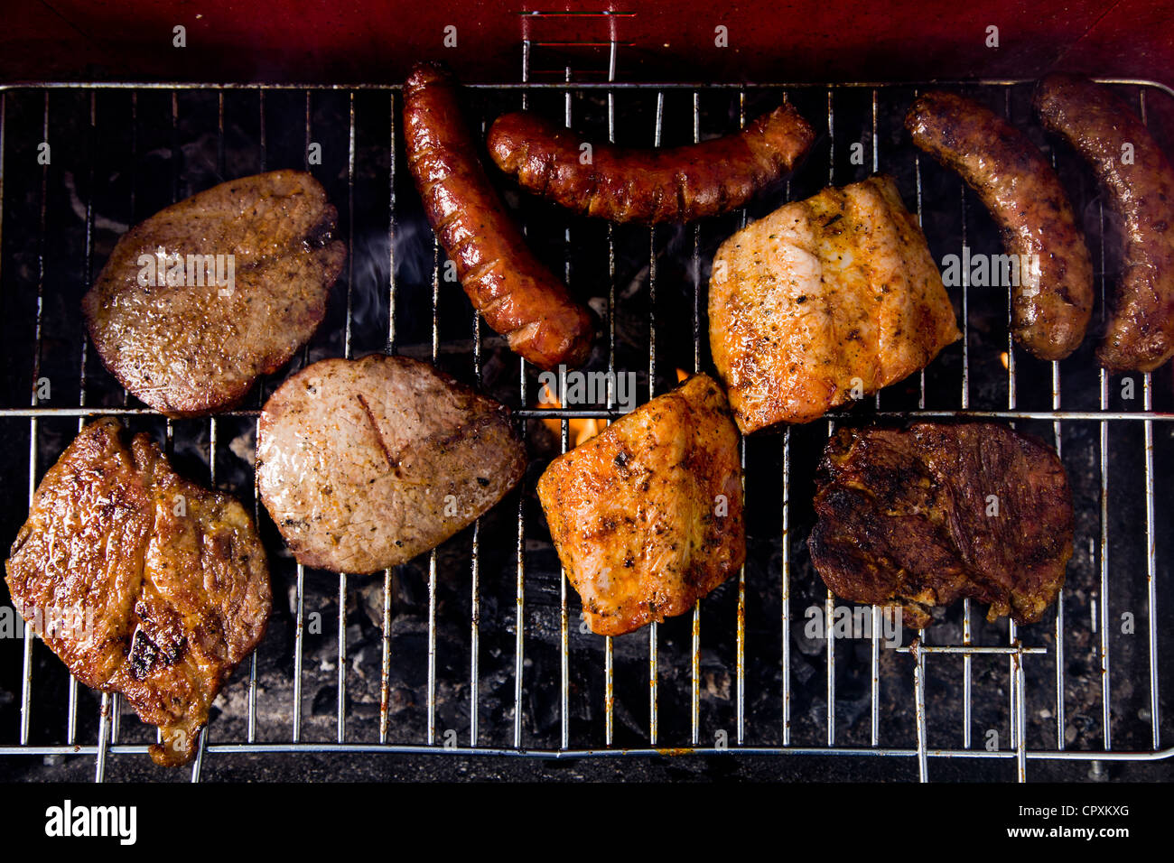 Closeup of fried meat on grill Stock Photo - Alamy