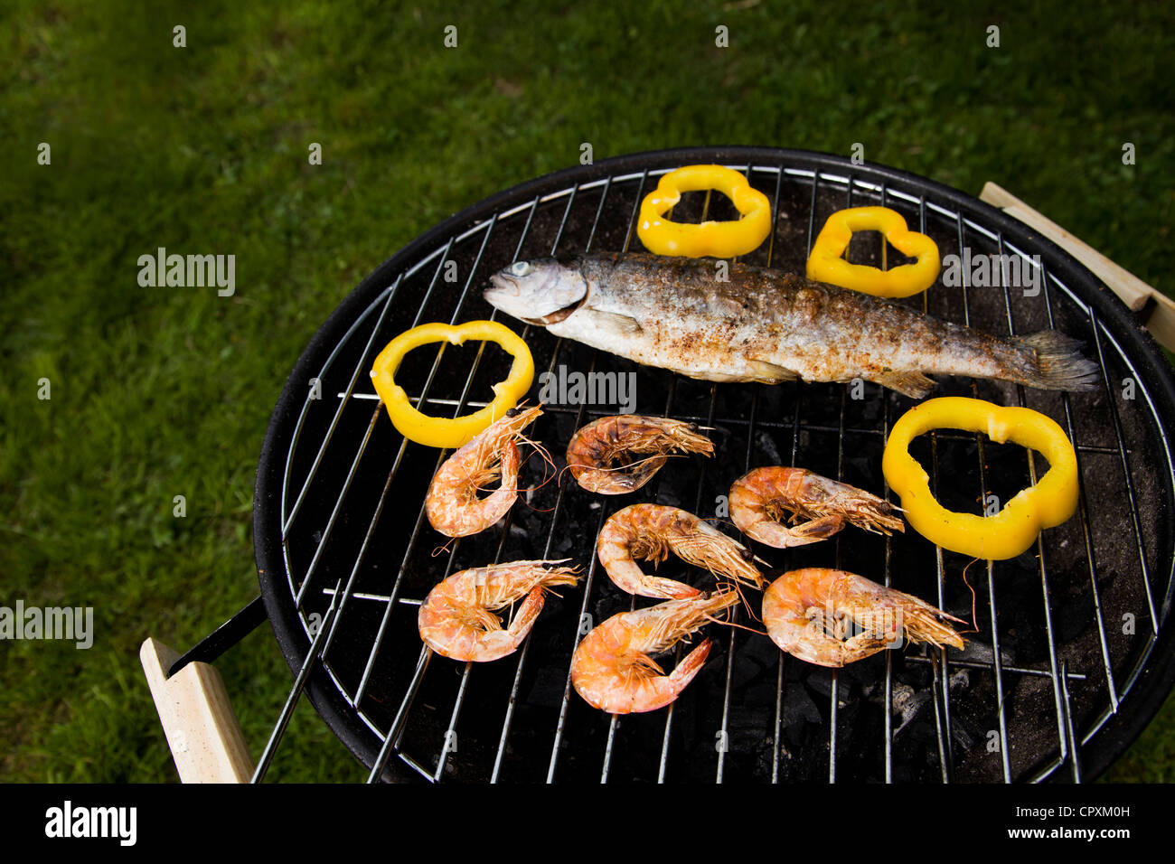 Seafood on grill. Fish and shrimps Stock Photo - Alamy