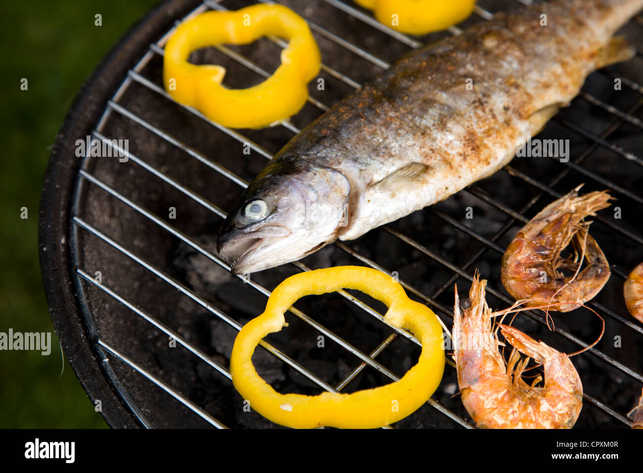 Seafood on grill. Fish and shrimps Stock Photo - Alamy