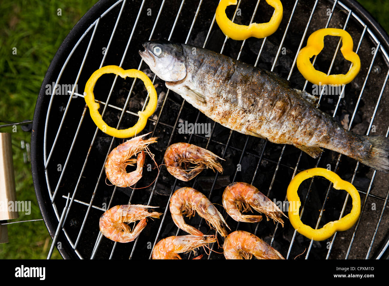 Seafood on grill. Fish and shrimps Stock Photo - Alamy