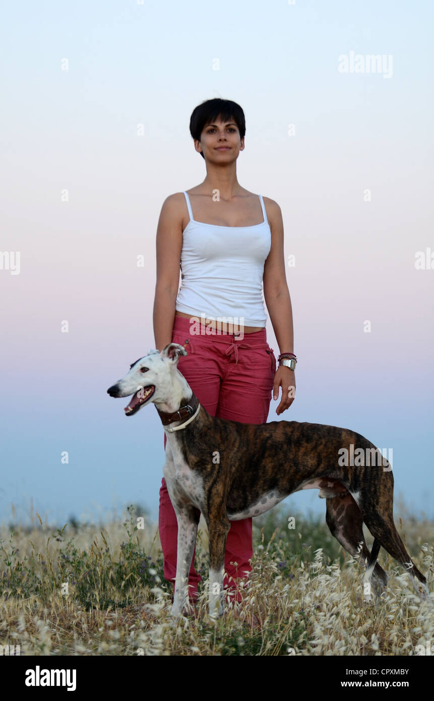 Attractive young woman with her dog in nature Stock Photo - Alamy