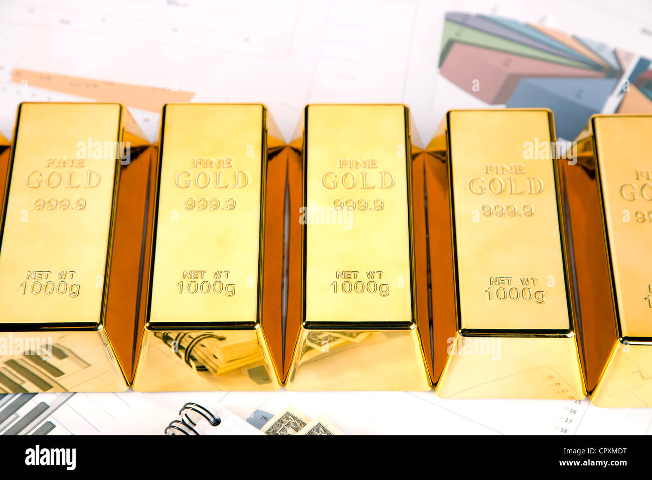 Gold bars on graphs and statistics Stock Photo - Alamy