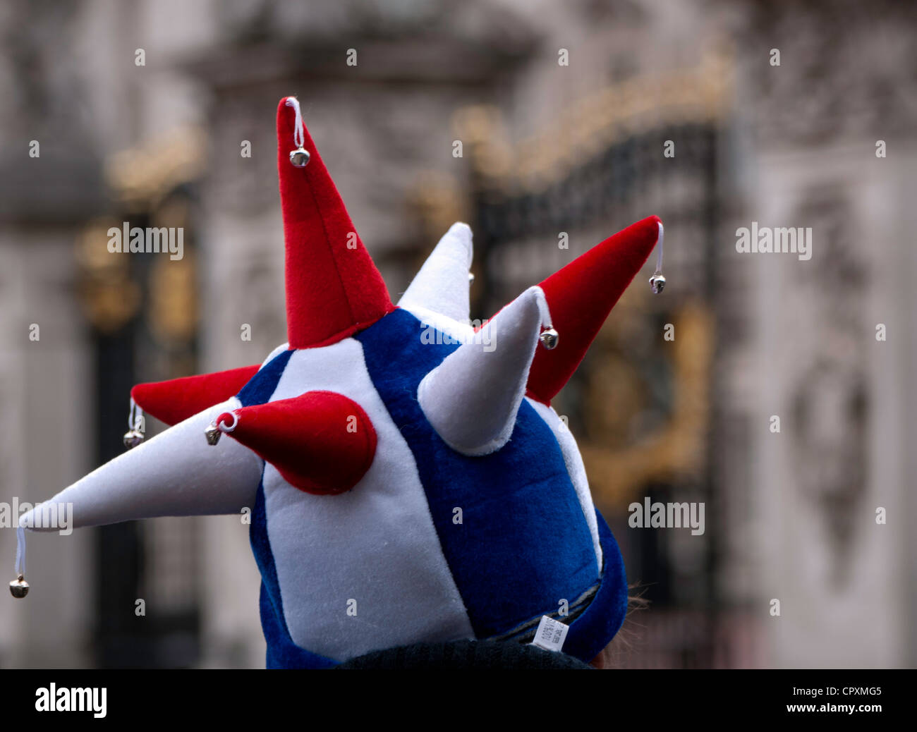 A red, white and blue jester's hat is worn outside Buckingham palace ...