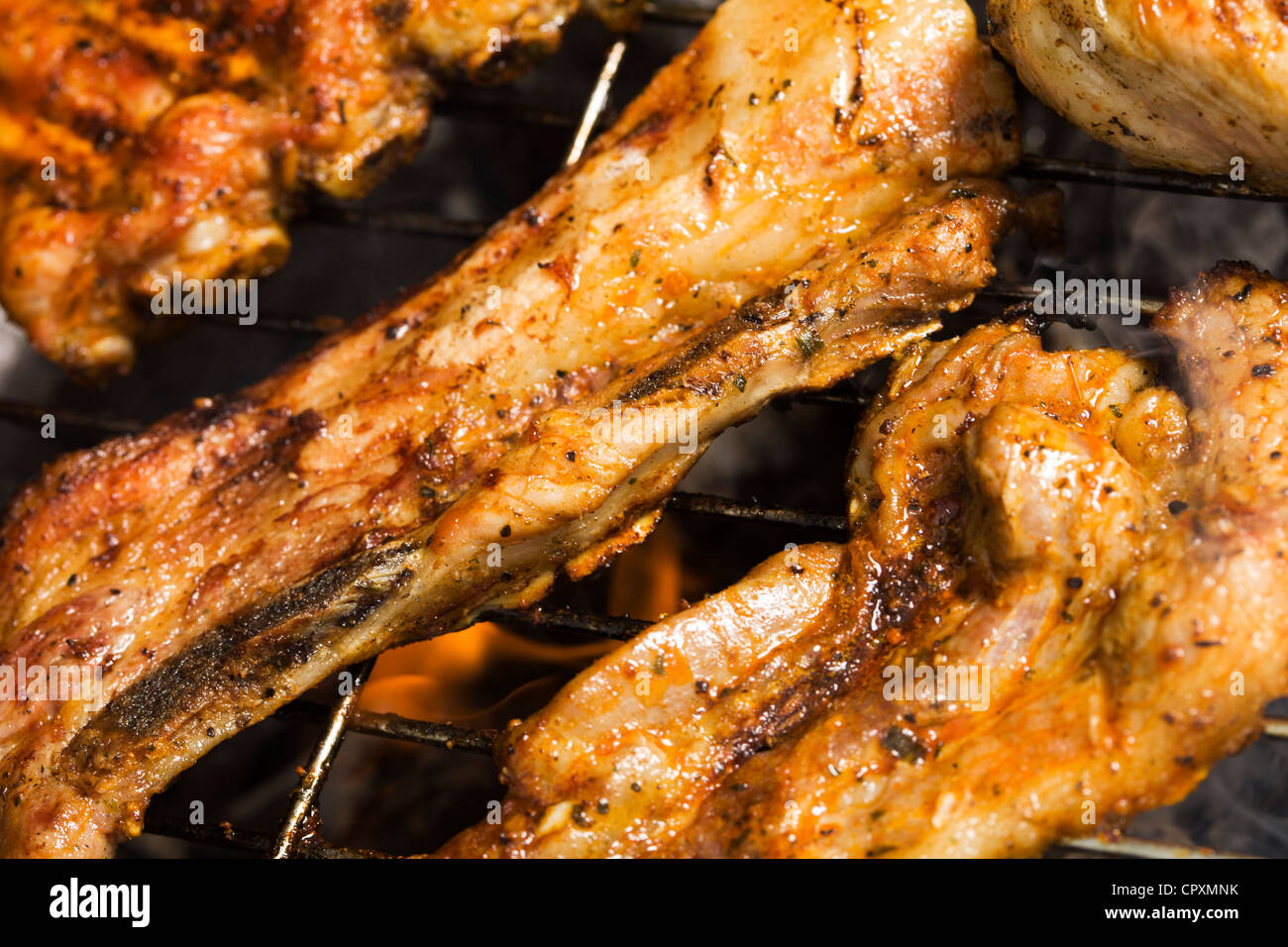Closeup of fried meat on grill Stock Photo - Alamy
